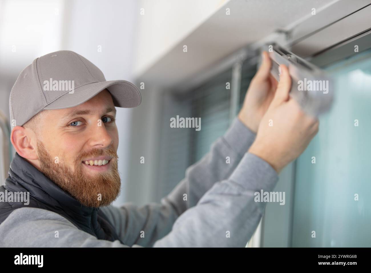 handyman installing a window shutter Stock Photo - Alamy