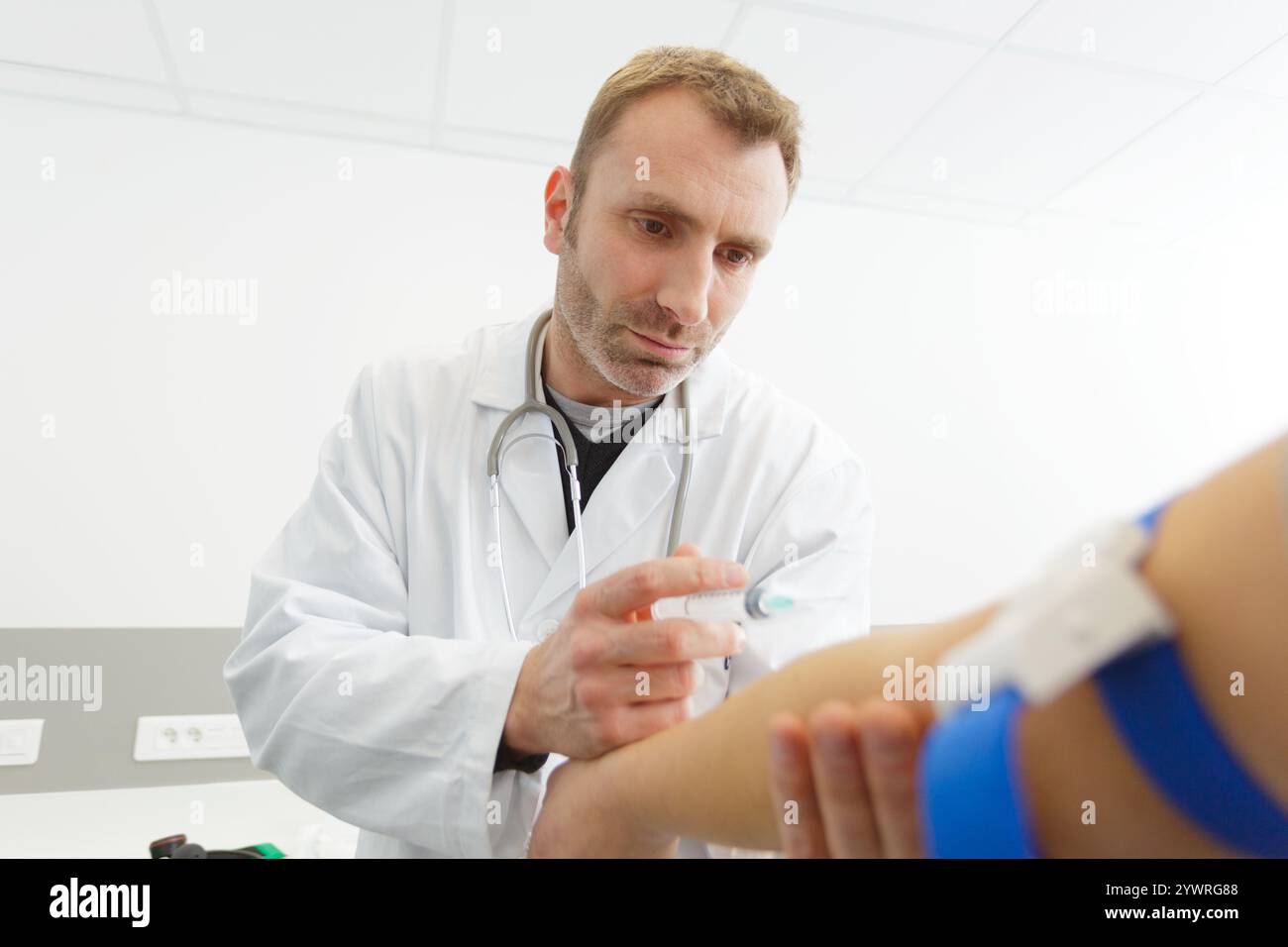 doctor with syringe doing injection of vaccine to male patient Stock ...