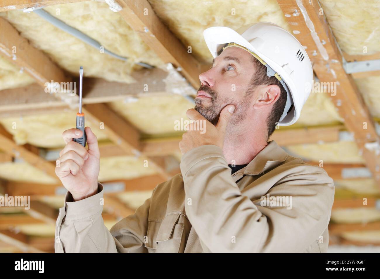 worker is fixing something in the ceiling Stock Photo - Alamy