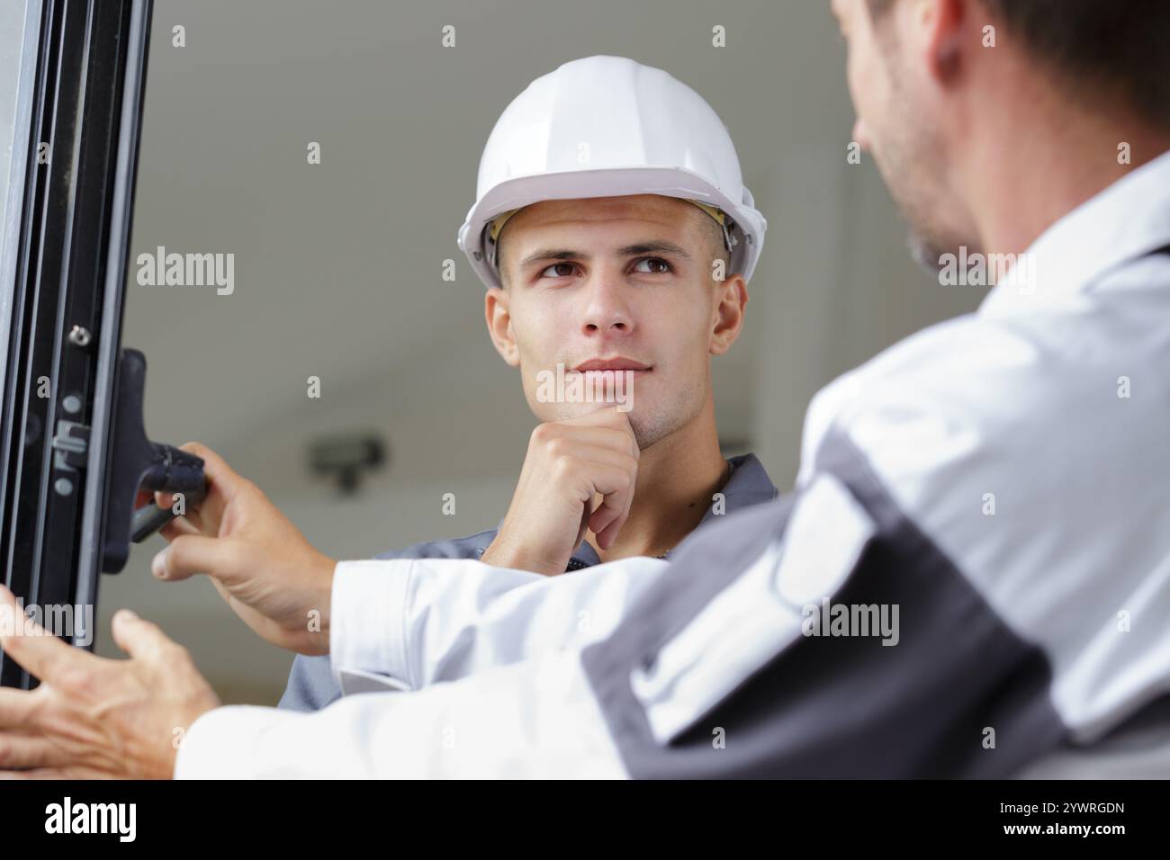 apprentice learning to measure windows Stock Photo - Alamy
