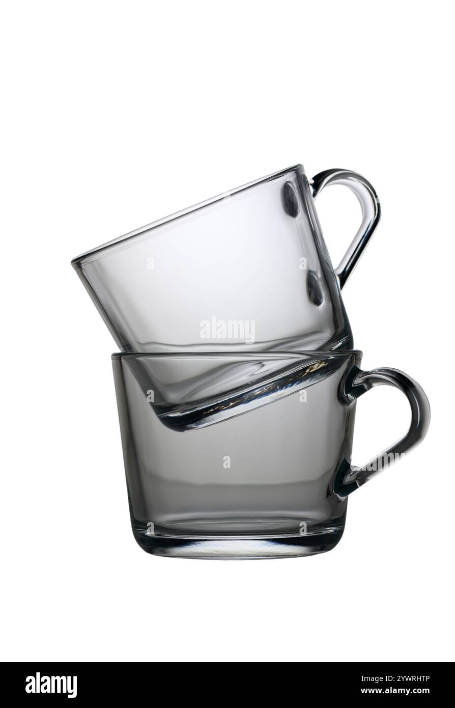 Two transparent glass cups are elegantly stacked, showcasing their ...