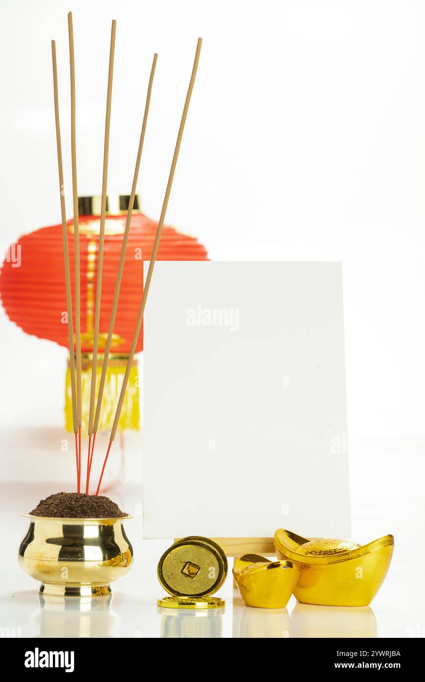 Incense on pot with paper and red Chinese lantern hanging on a white ...
