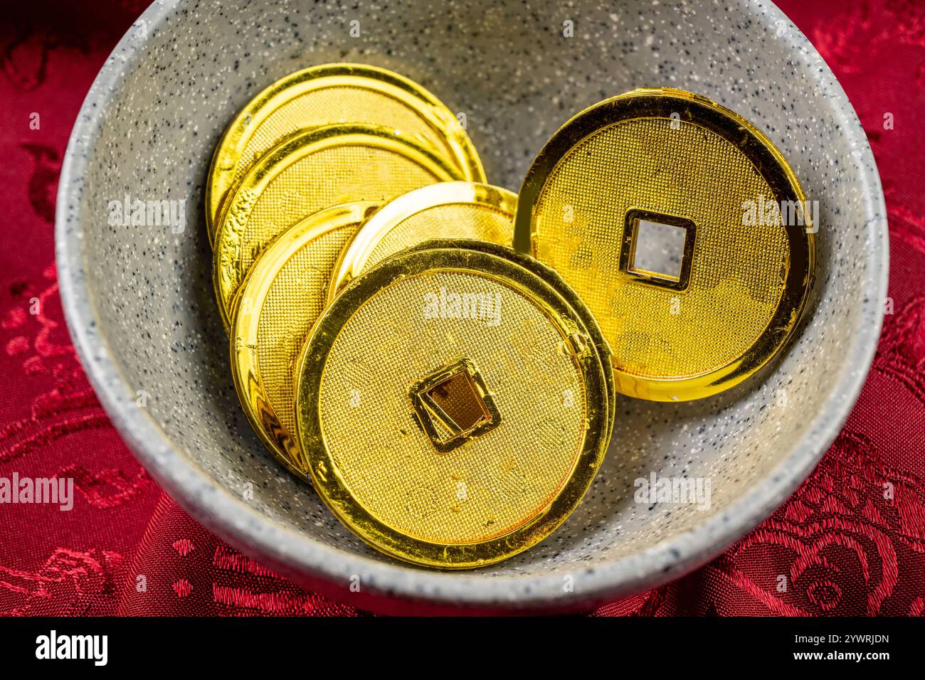 Traditional Chinese golden coins on the bowl with a red cloth ...