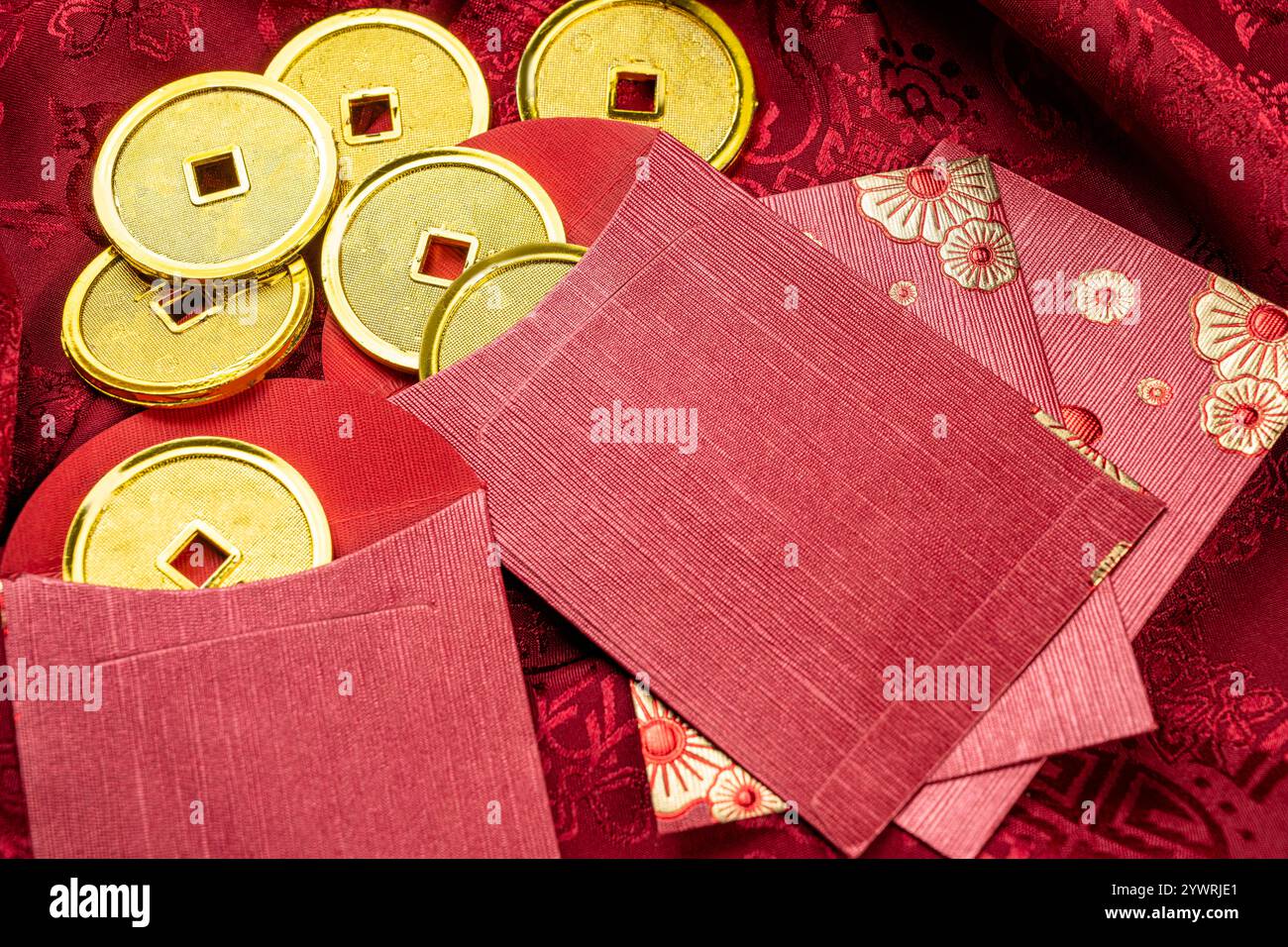 The pile of red envelopes or angpao with golden Chinese coins on a red ...