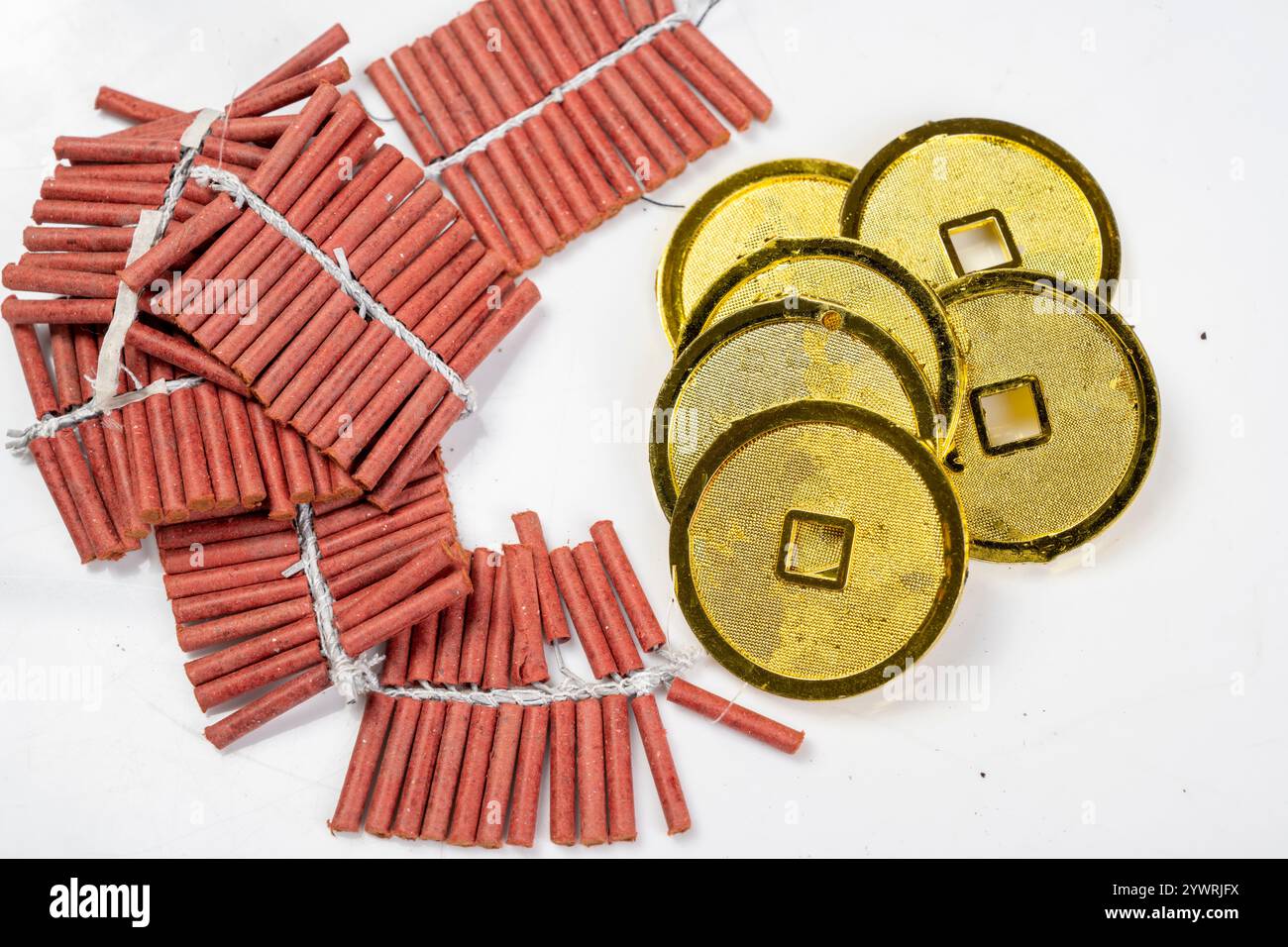 The pile of Chinese golden coins and a string of Chinese firecrackers ...