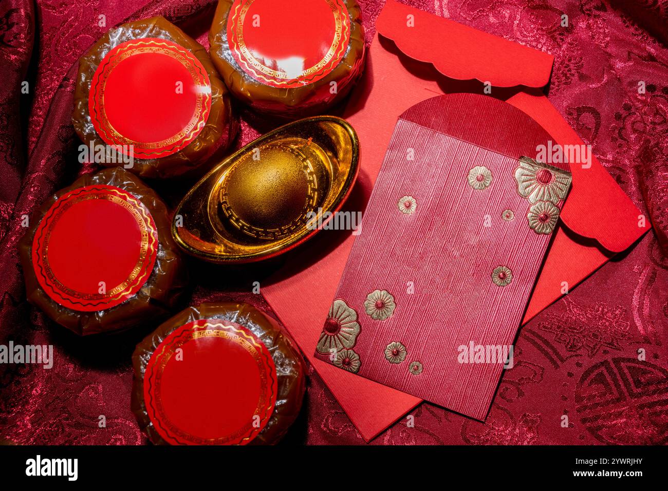 Chinese New Year rice cake or Nian Gao with red envelopes or angpao and ...