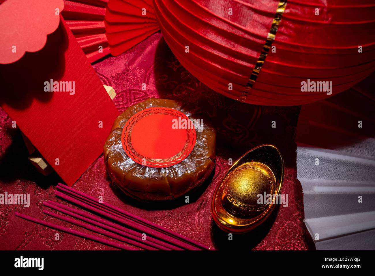 Chinese New Year rice cake or Nian Gao with red envelopes or angpao and ...