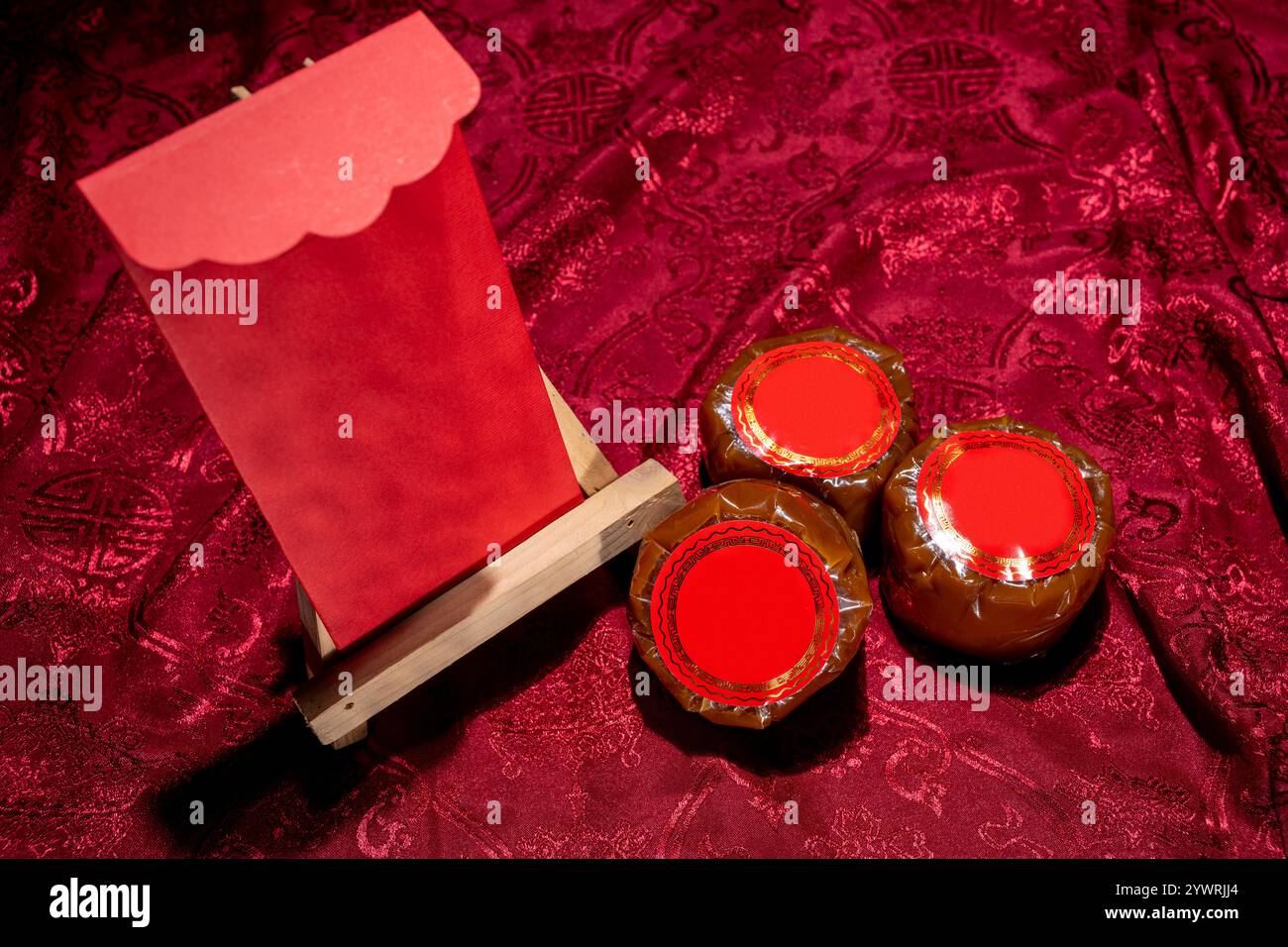 Chinese New Year rice cake or Nian Gao with red envelopes or angpao on ...