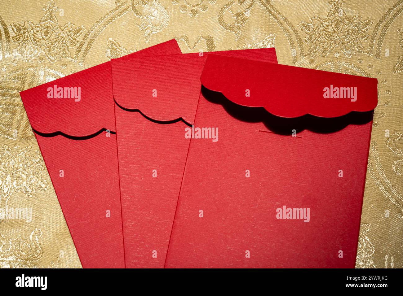 The pile of red envelopes or angpao with a yellow cloth background ...