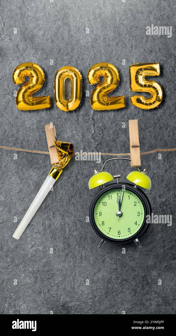 Golden helium balloons with the number 2025 and an alarm clock with a ...