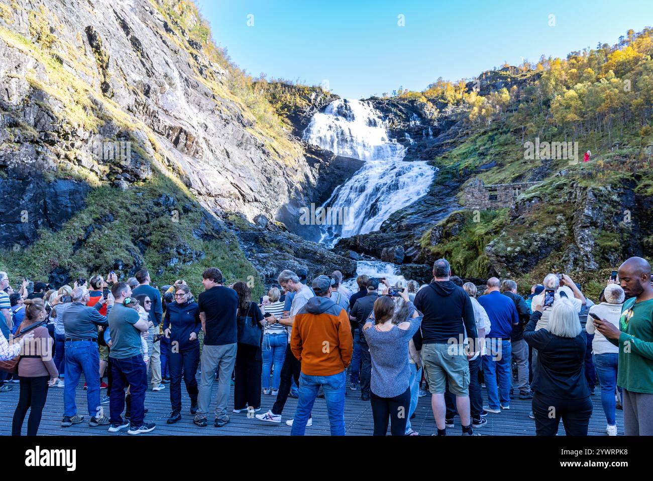 Tourists disembark Flam railway train to view Kjosfossen waterfall ...