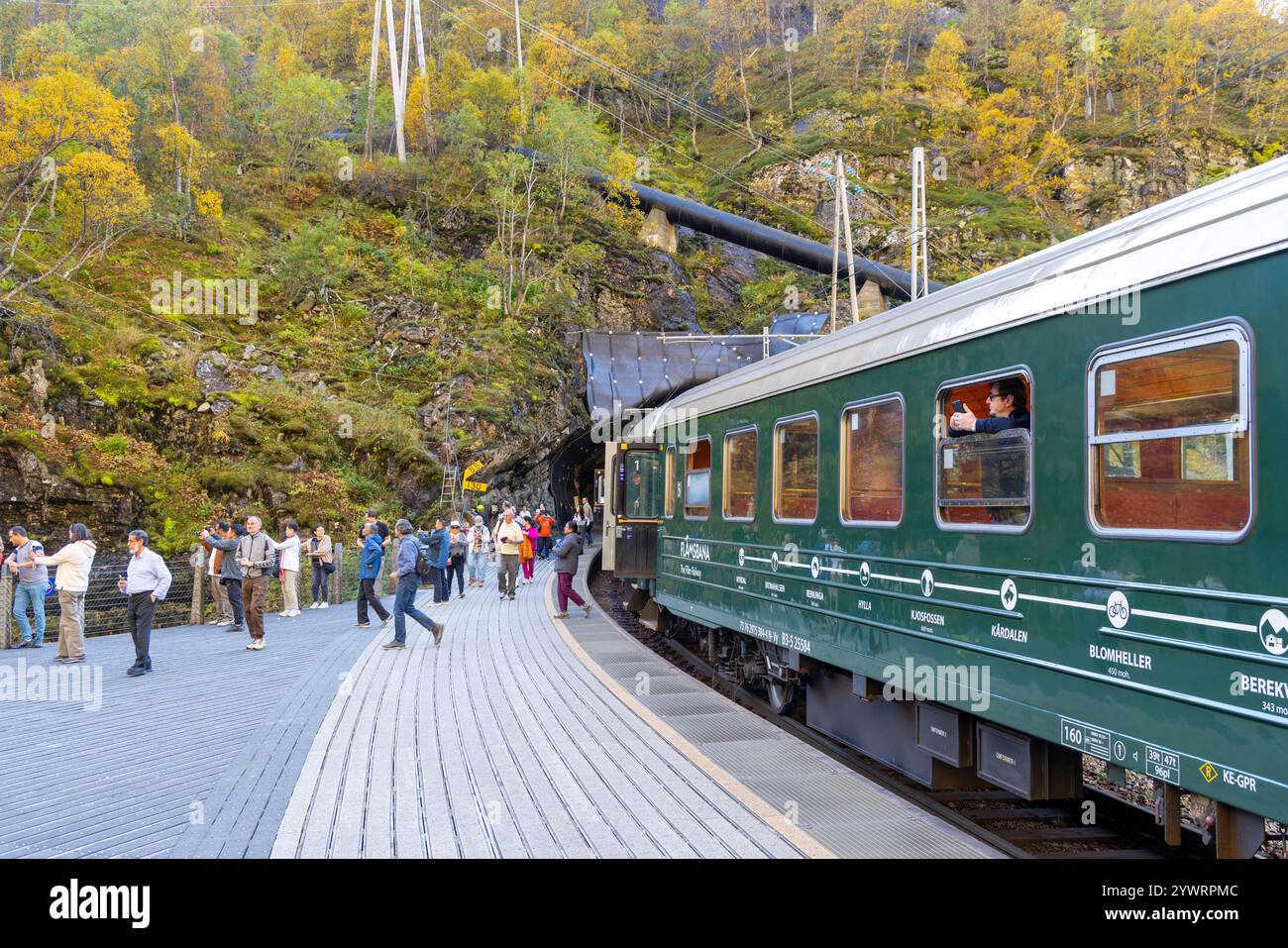 Tourists disembark Flam railway train to view Kjosfossen waterfall on the journey between Flam ...
