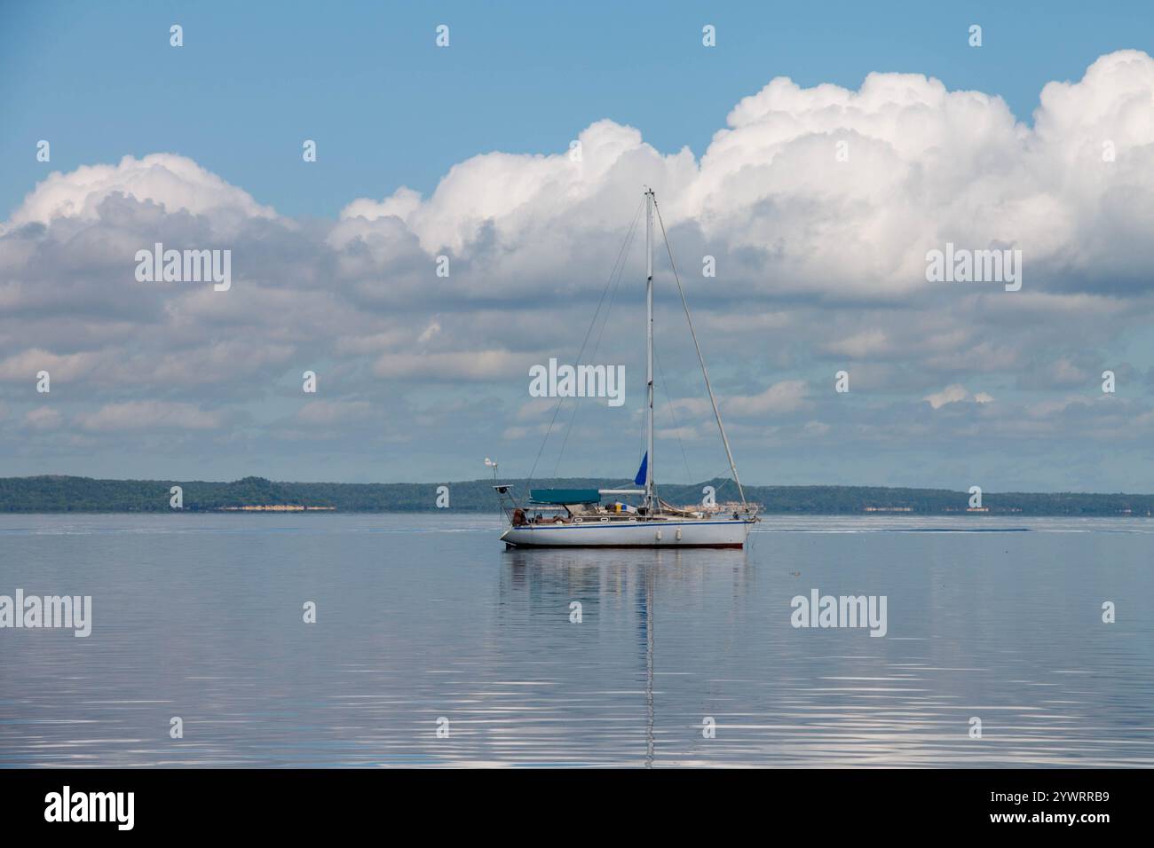 A Sailboat yacht sailing in the tranquil waters of Bahia de Cienfuegos ...
