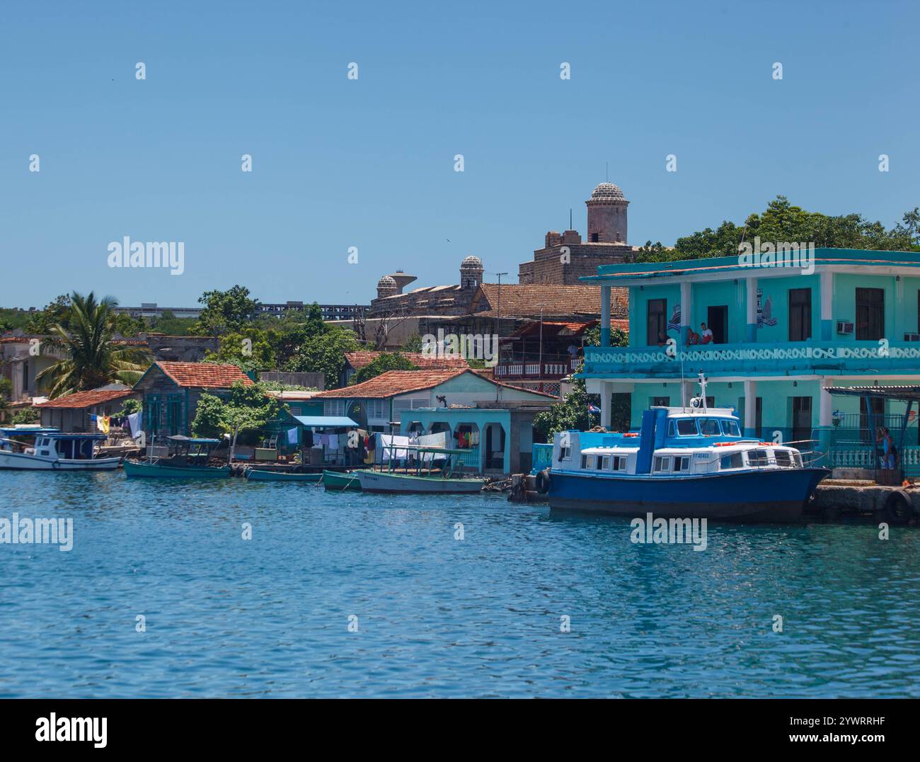 Fishing boats in a small village and castillo de jagua in bahia de ...