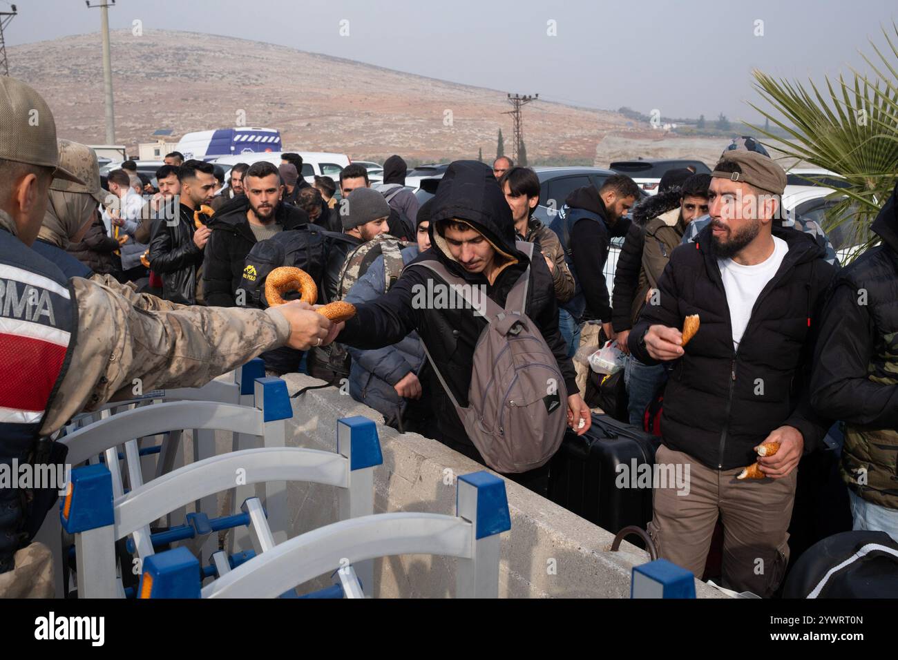 Hatay, Turkey. 11th Dec, 2024. Turkish soldiers distribute bagels to ...