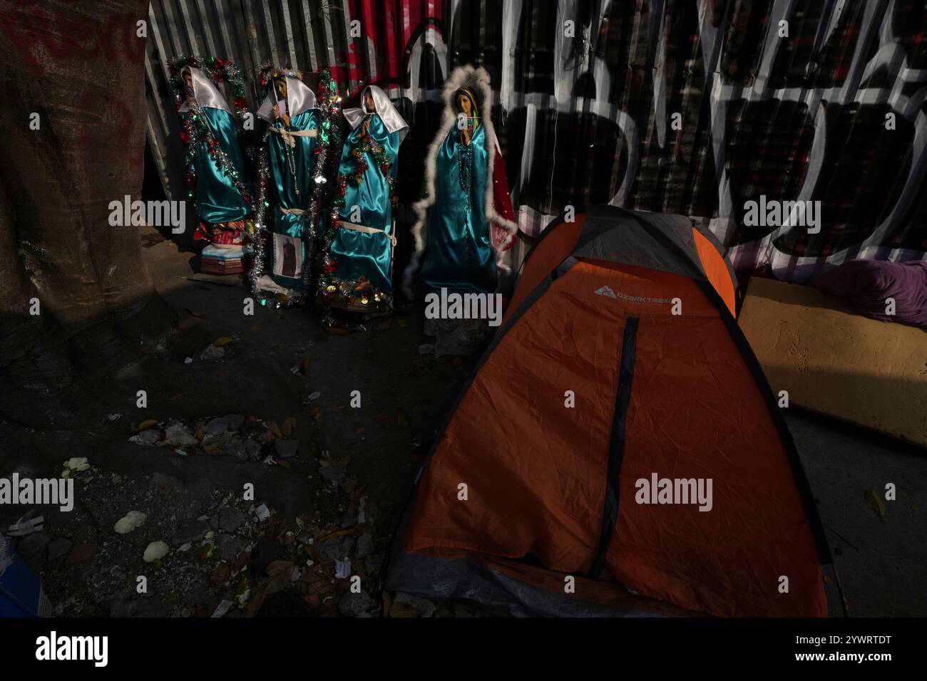 Pilgrims rest in a tent near the Basilica of Our Lady of Guadalupe a ...