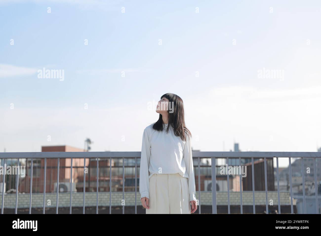 Female standing on rooftop Stock Photo - Alamy