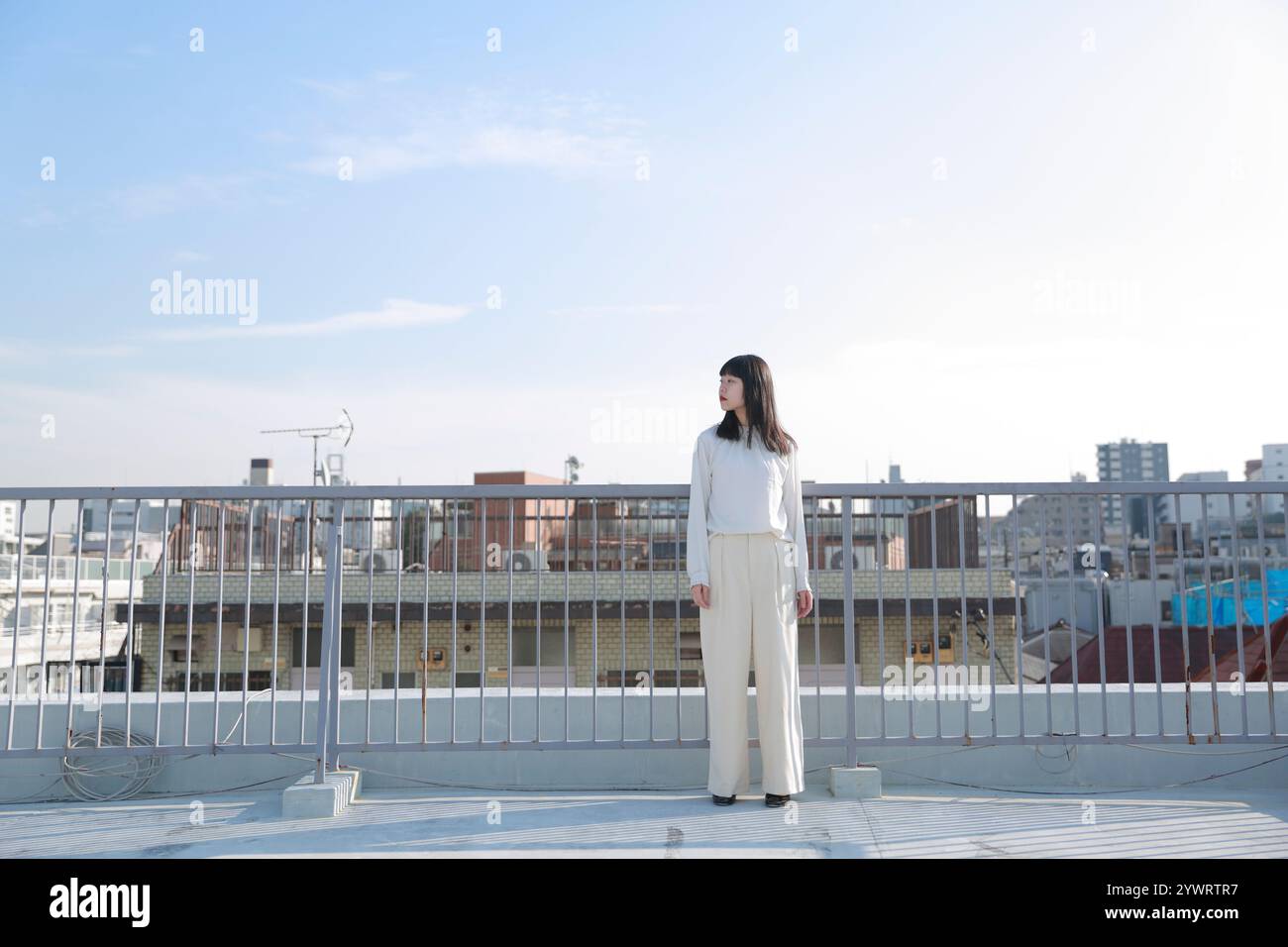 Female standing on rooftop Stock Photo - Alamy
