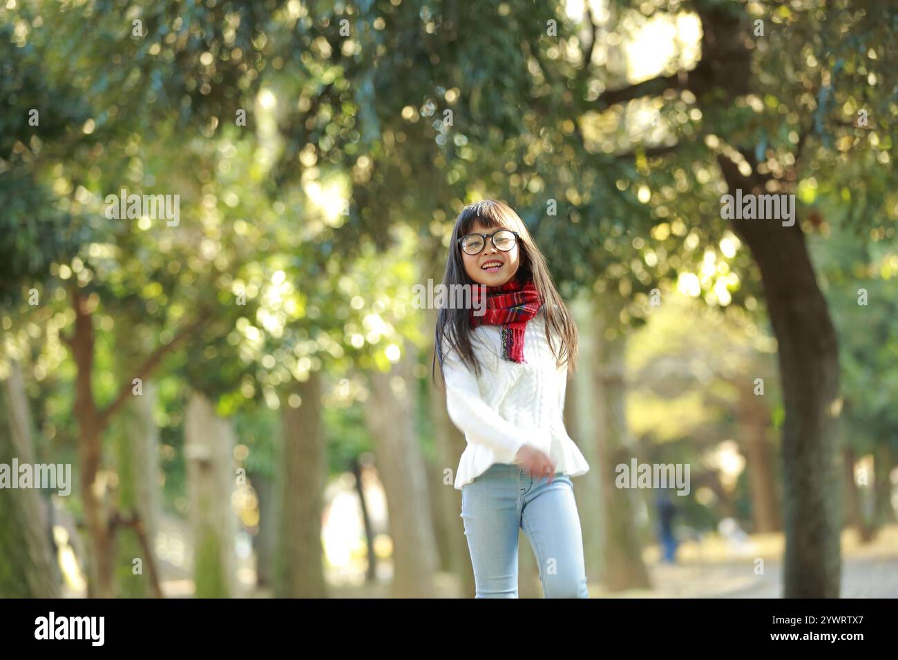 Woman walking through green park hi-res stock photography and images ...