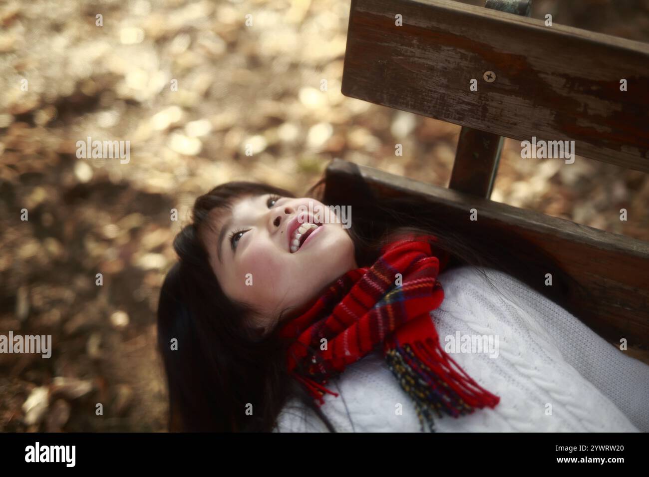Girl lying on bench Stock Photo - Alamy