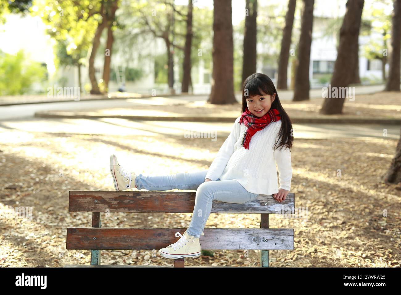 Girl posing on bench Stock Photo - Alamy