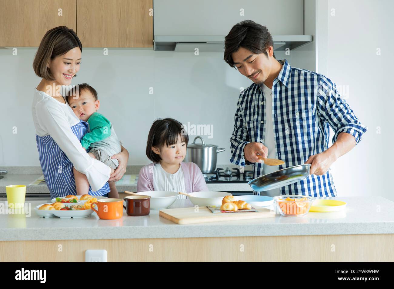 Japanese family of four preparing lunch Stock Photo - Alamy