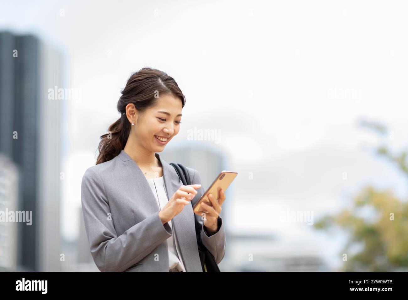 Woman operating smartphone outside hi-res stock photography and images ...