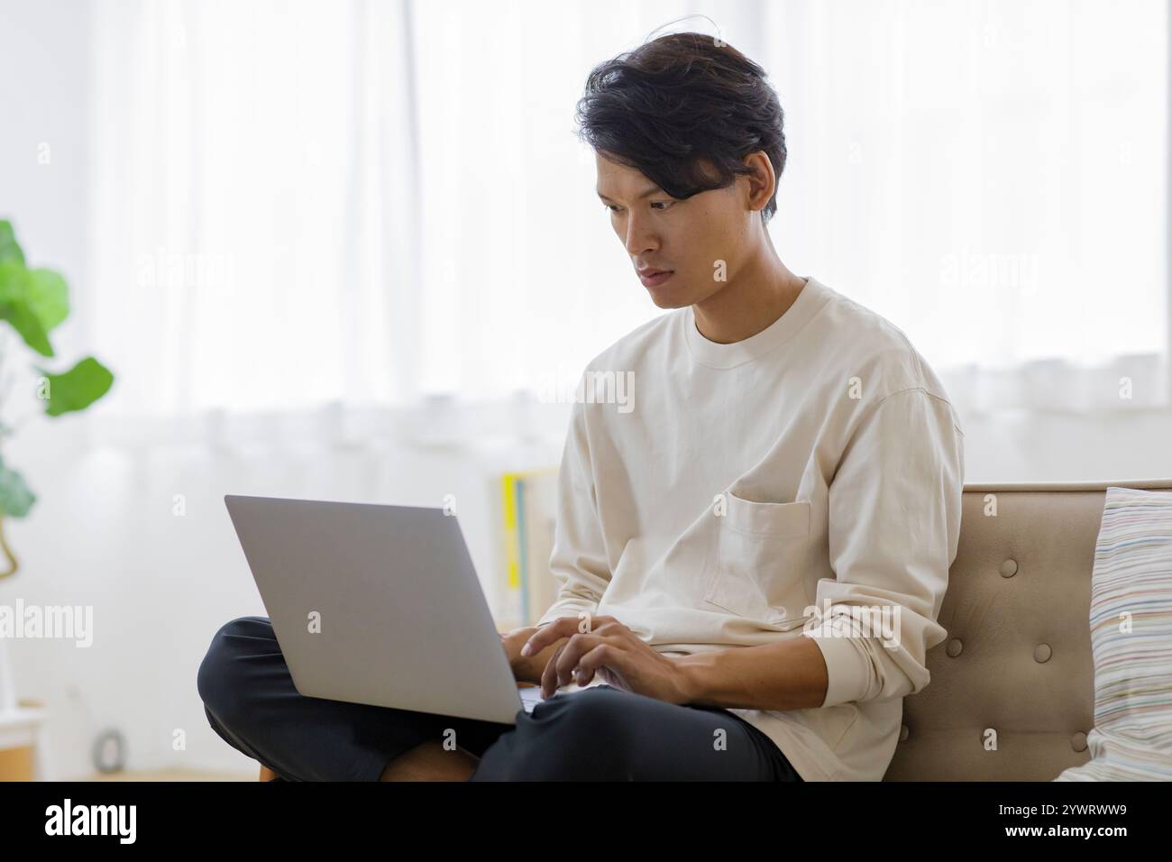 Japanese man operating laptop computer Stock Photo - Alamy