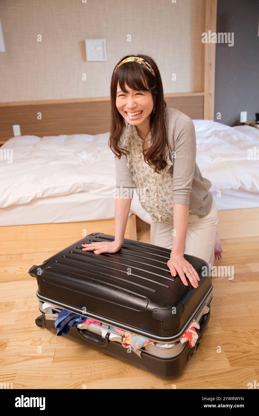 Woman hand packing suitcase hi-res stock photography and images - Alamy