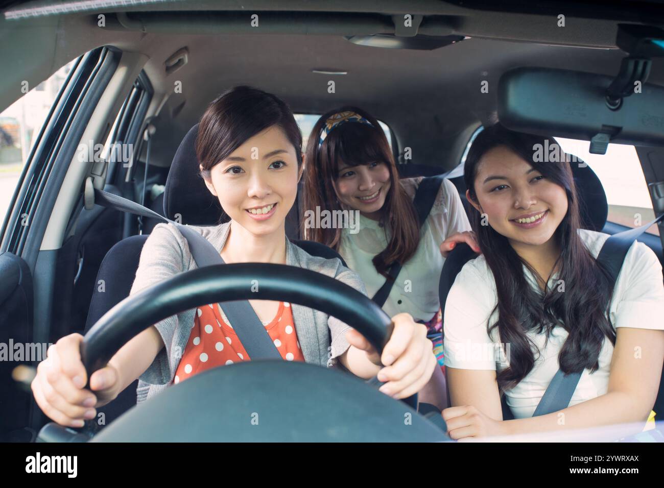 Three young women driving Stock Photo - Alamy