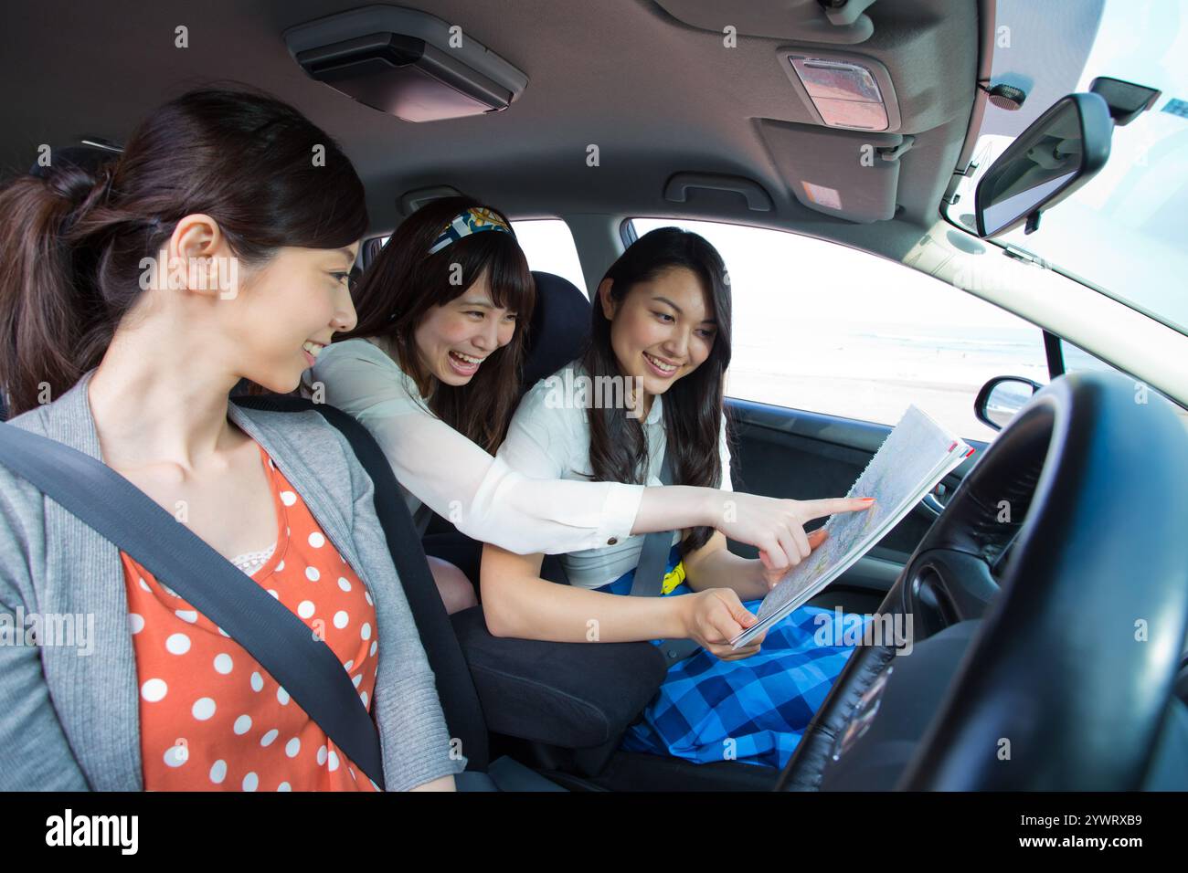 Three young women discussing in car Stock Photo - Alamy
