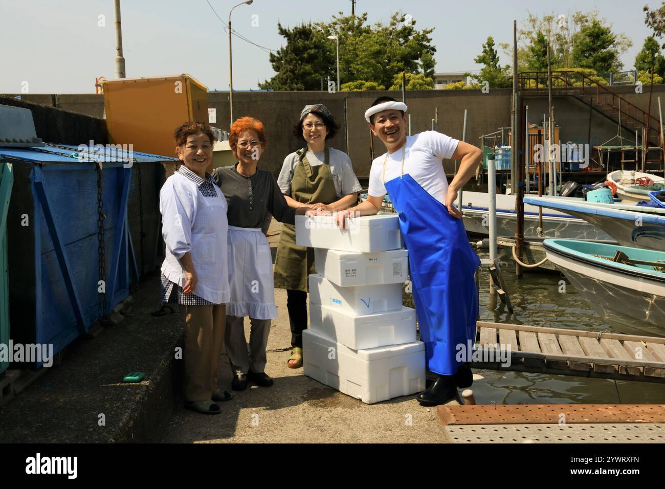 Fresh fish shopkeeper selling fish outdoors with female customers Stock ...