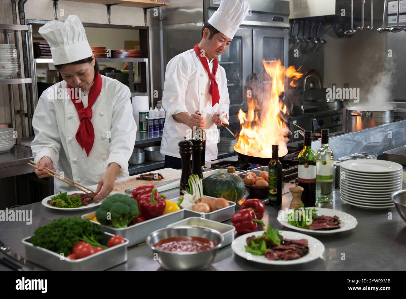 Two cooks working in the kitchen Stock Photo - Alamy