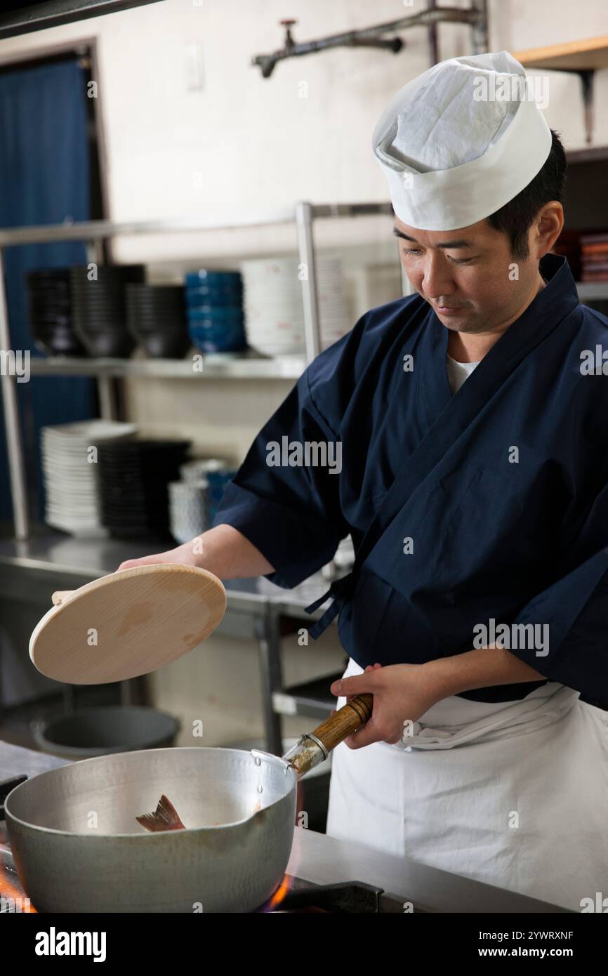 Cook with fallen lid Stock Photo - Alamy