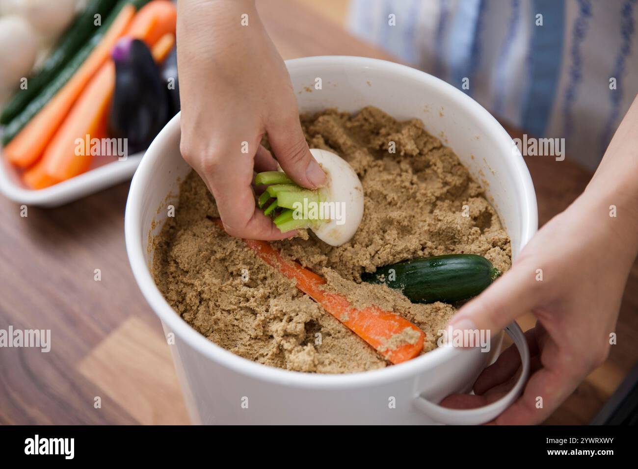 Woman soaking vegetables in bran Stock Photo - Alamy