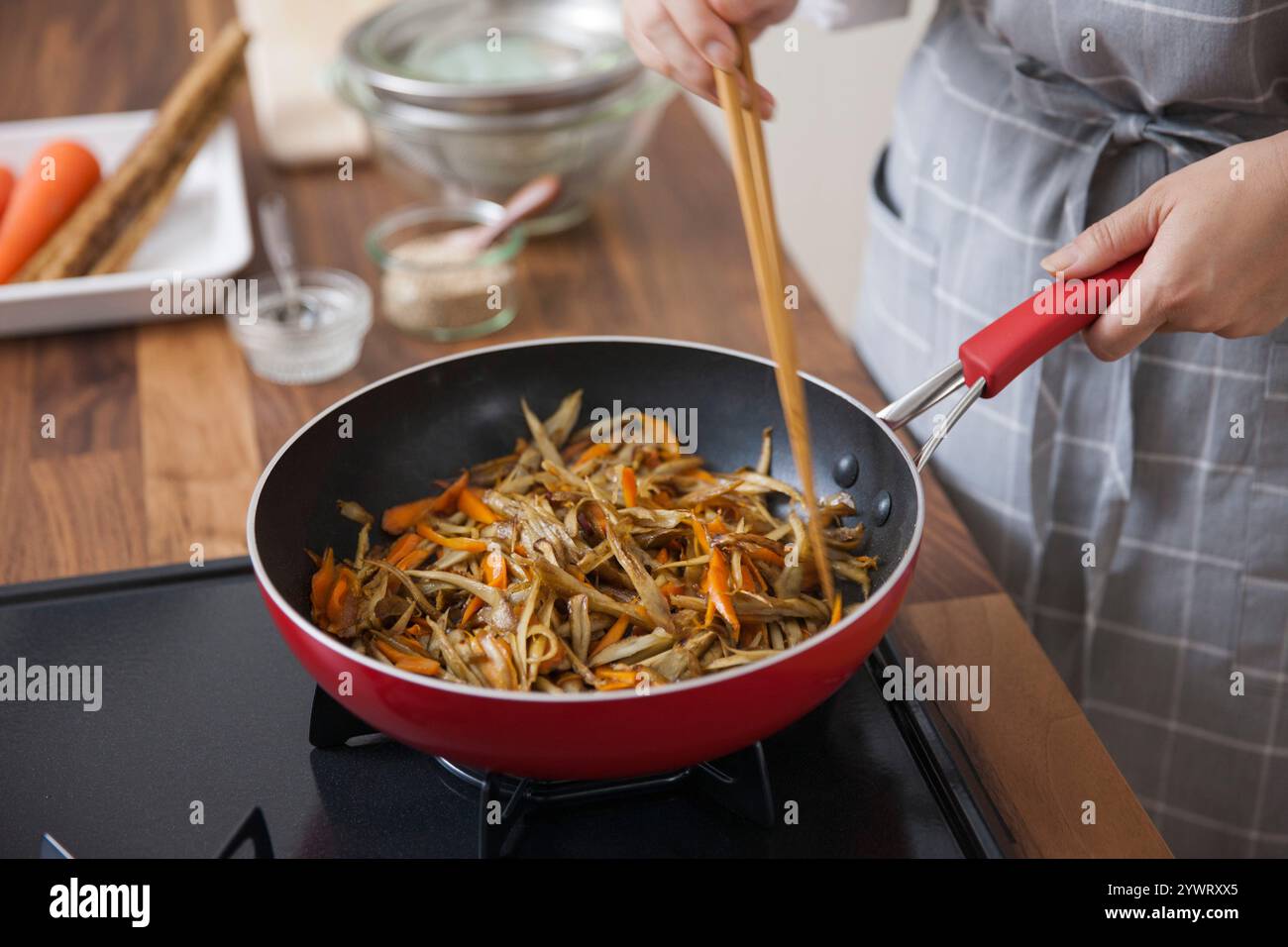 Woman finishing the kinpira gobo Stock Photo - Alamy