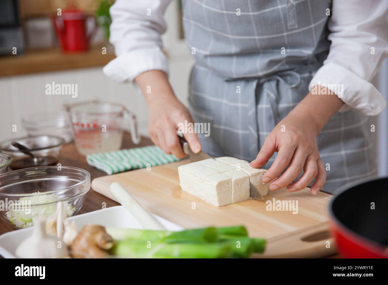 Woman cutting tofu Stock Photo - Alamy