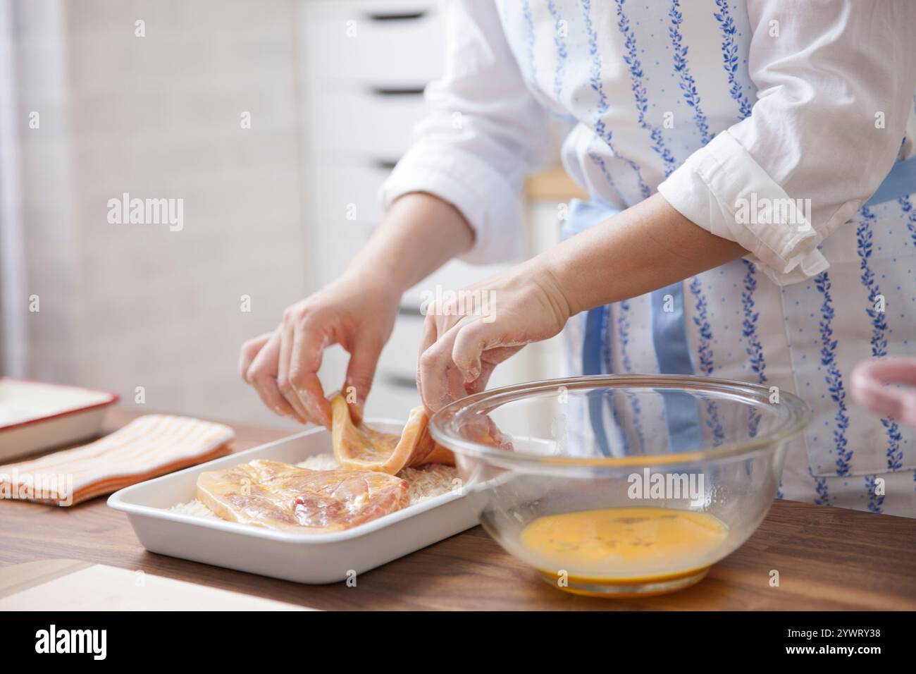 Woman breading pork loin Stock Photo - Alamy