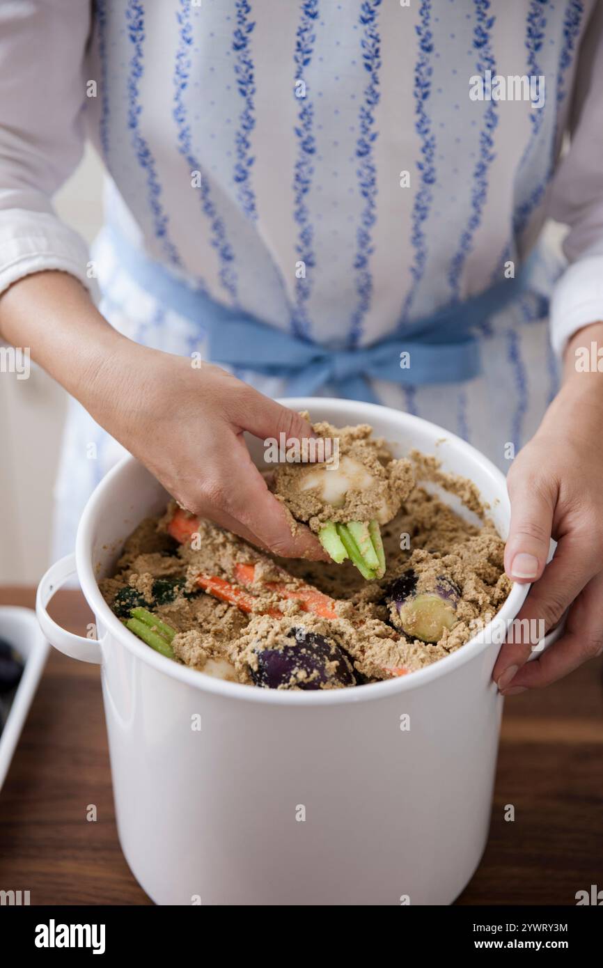 Woman soaking vegetables in bran Stock Photo - Alamy
