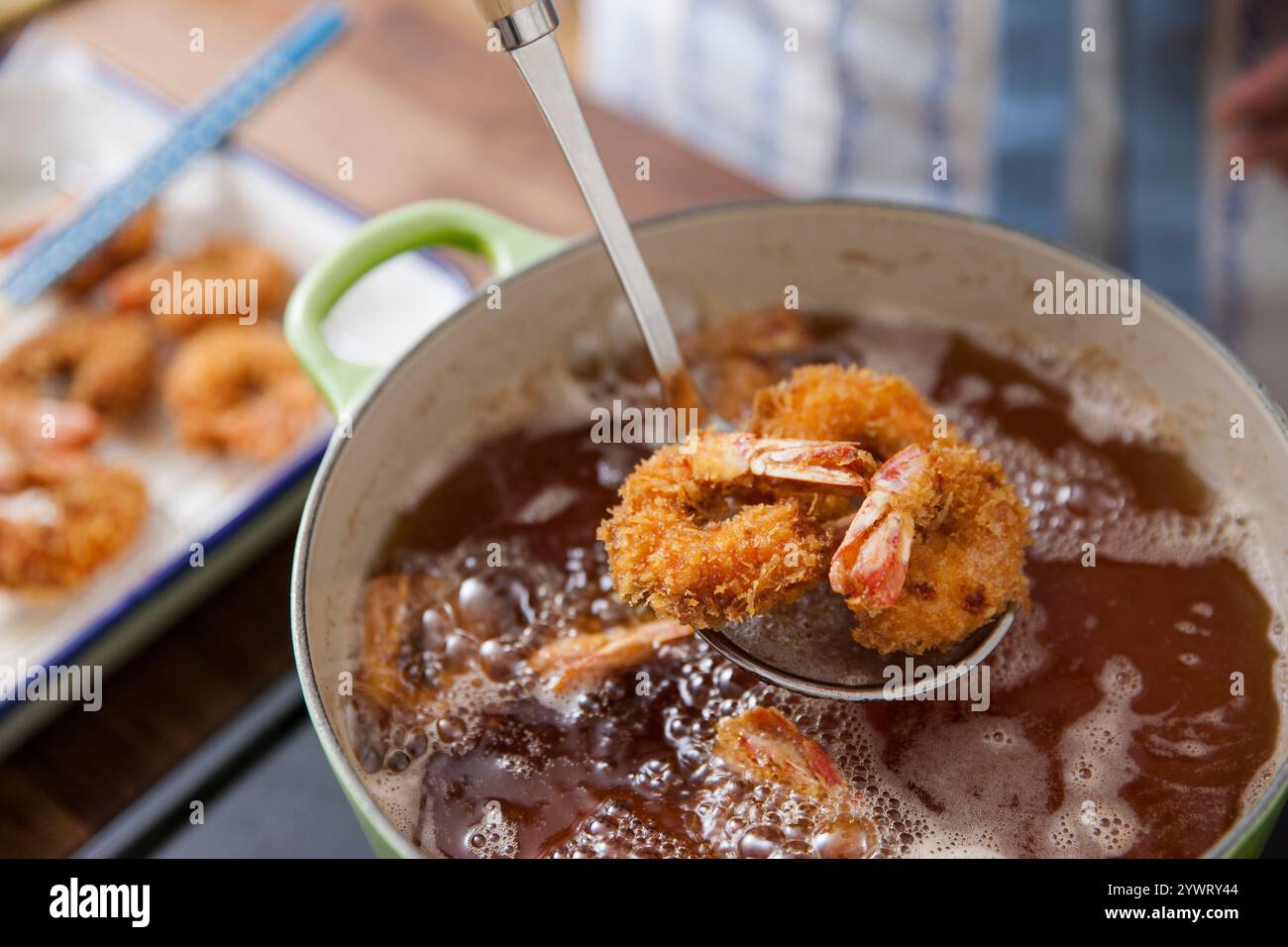 Woman frying fried prawns in oil Stock Photo - Alamy