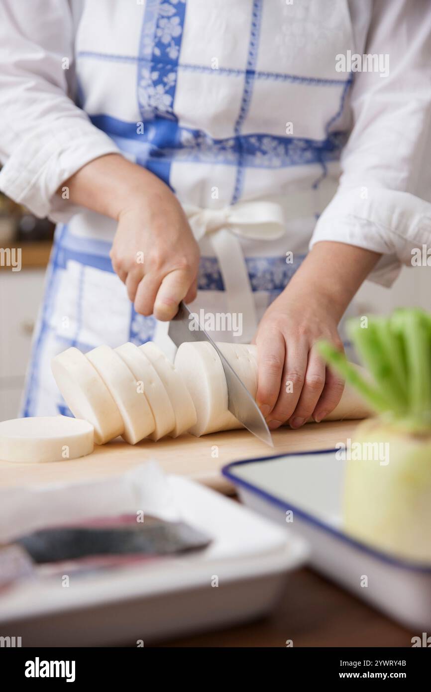 Woman cutting radish into round slices Stock Photo - Alamy