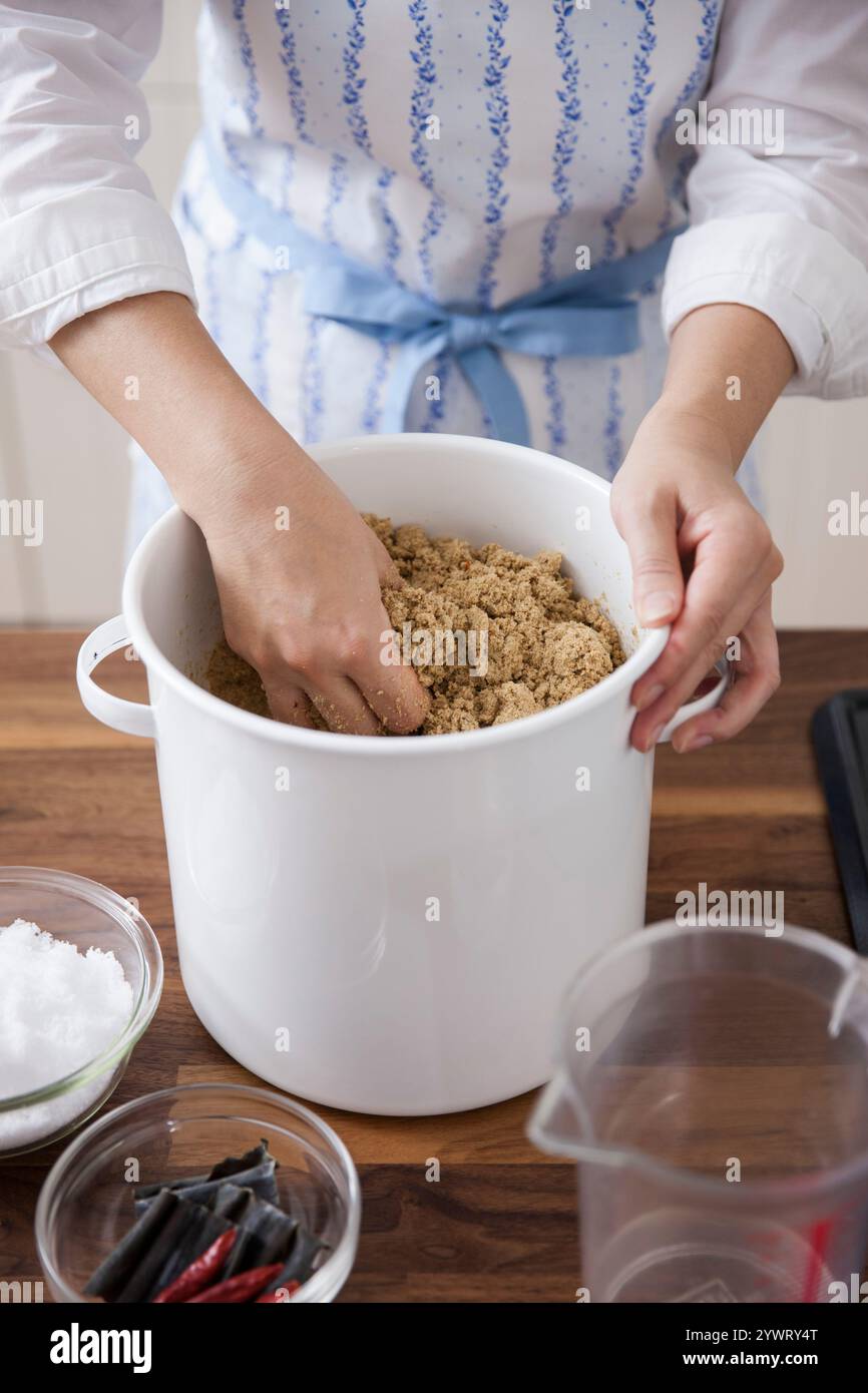 Woman stirring bran and salt water Stock Photo - Alamy