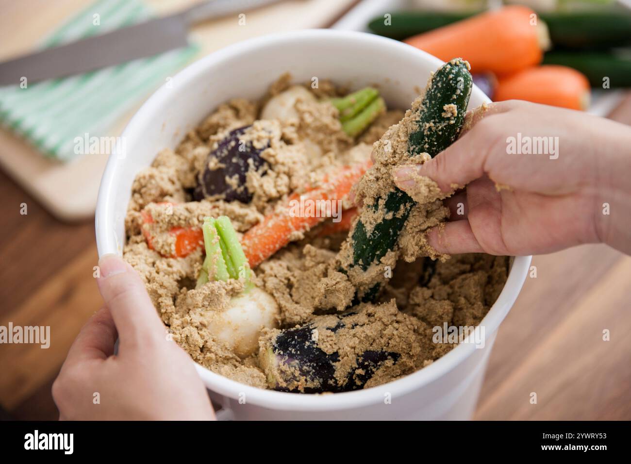 Woman soaking vegetables in bran Stock Photo - Alamy