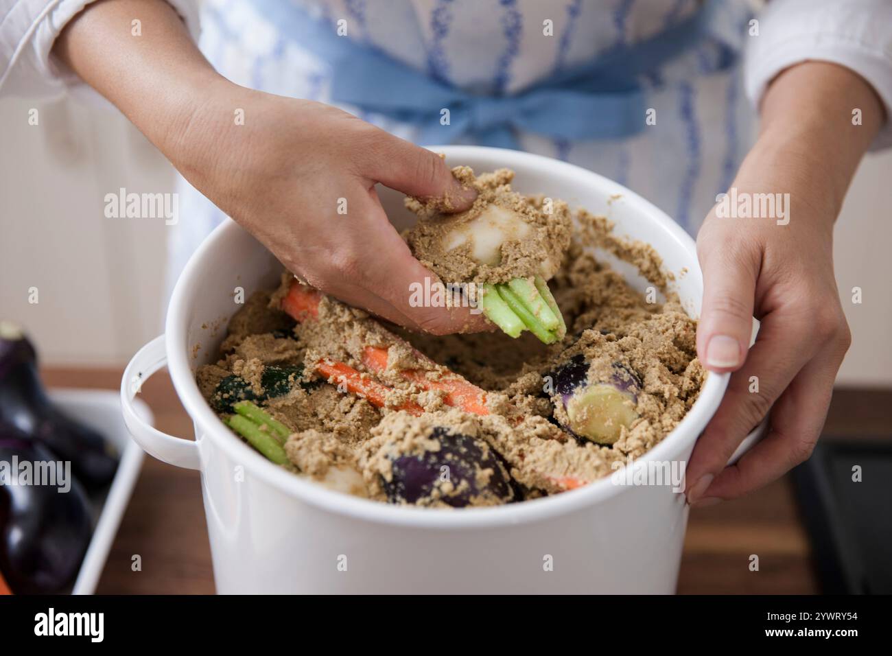 Woman soaking vegetables in bran Stock Photo - Alamy