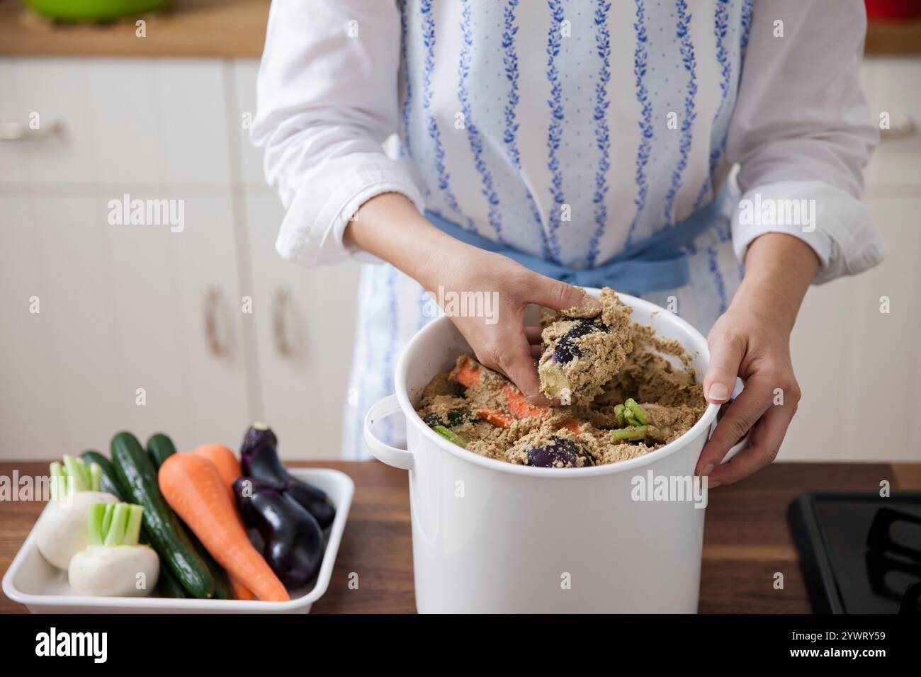 Woman soaking vegetables in bran Stock Photo - Alamy
