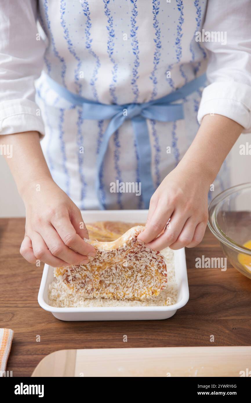 Woman breading pork loin Stock Photo - Alamy