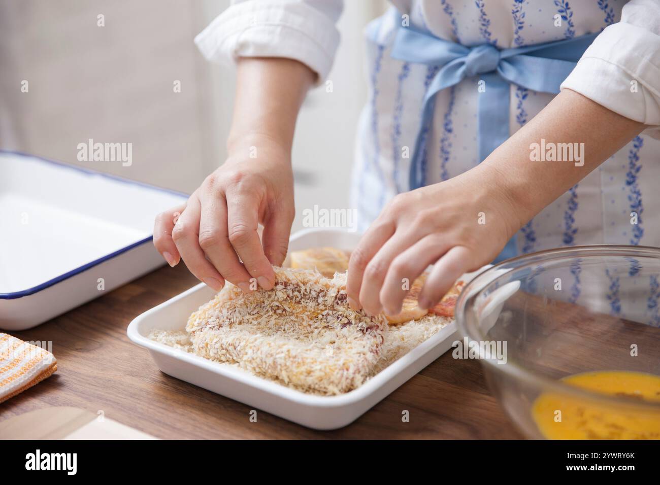 Woman breading pork loin Stock Photo - Alamy