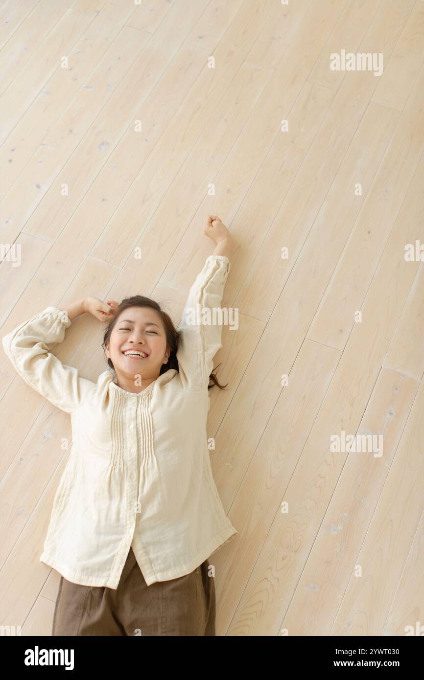 Young woman lying floor hi-res stock photography and images - Alamy
