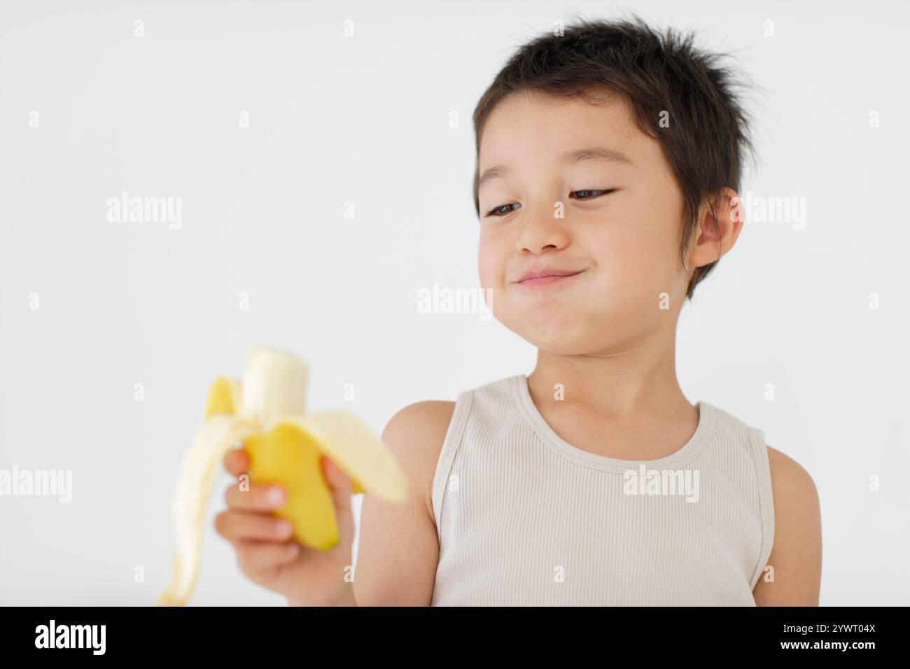 Boy eating banana Stock Photo - Alamy