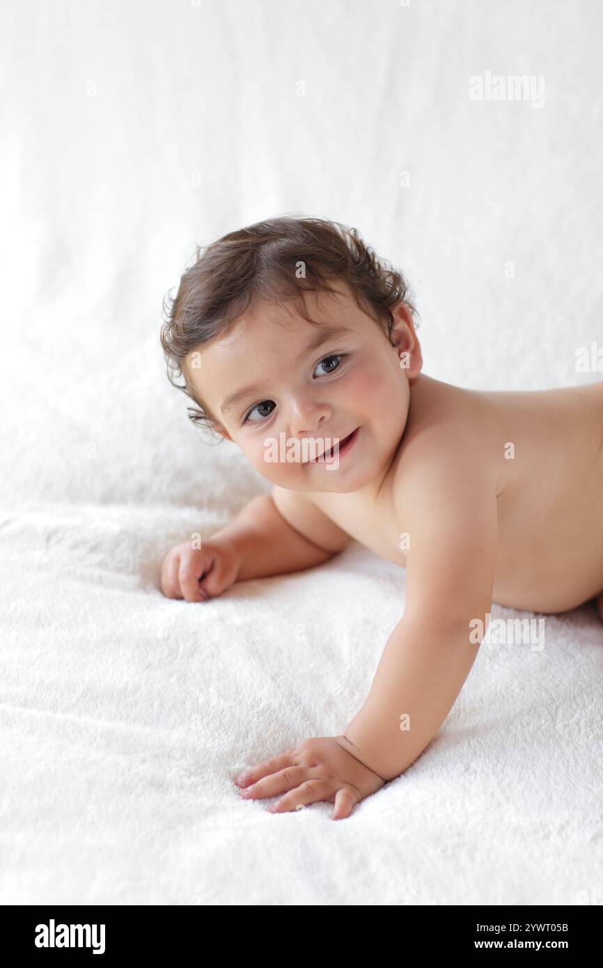 Foreign baby lying on bed Stock Photo - Alamy